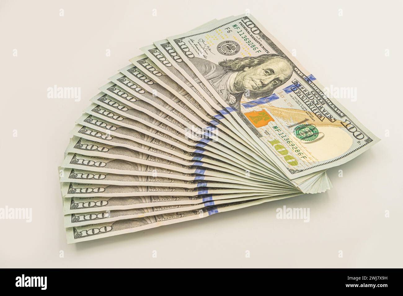 Fan of one hundred dollar bills isolated on white background. American ...