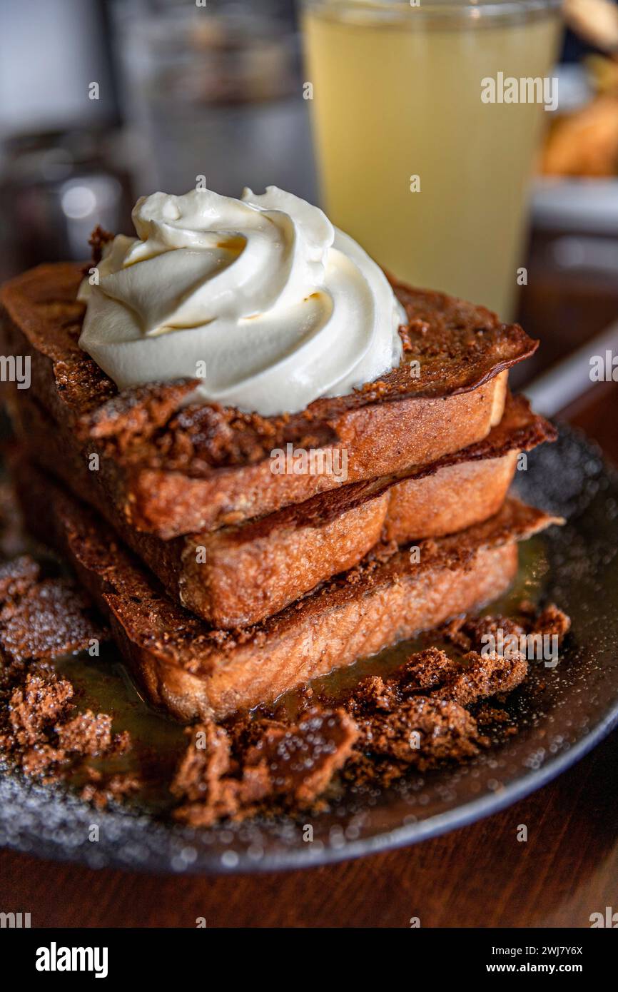 A refreshing glass of lemonade is placed alongside a delectable stack ...