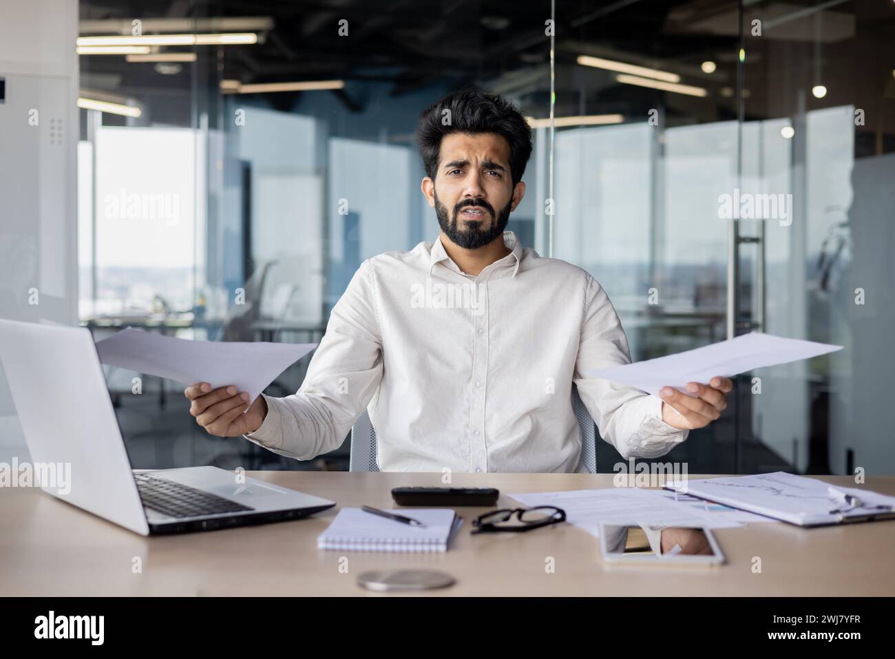 Financial problems with documents and accounts. Young Indian office ...