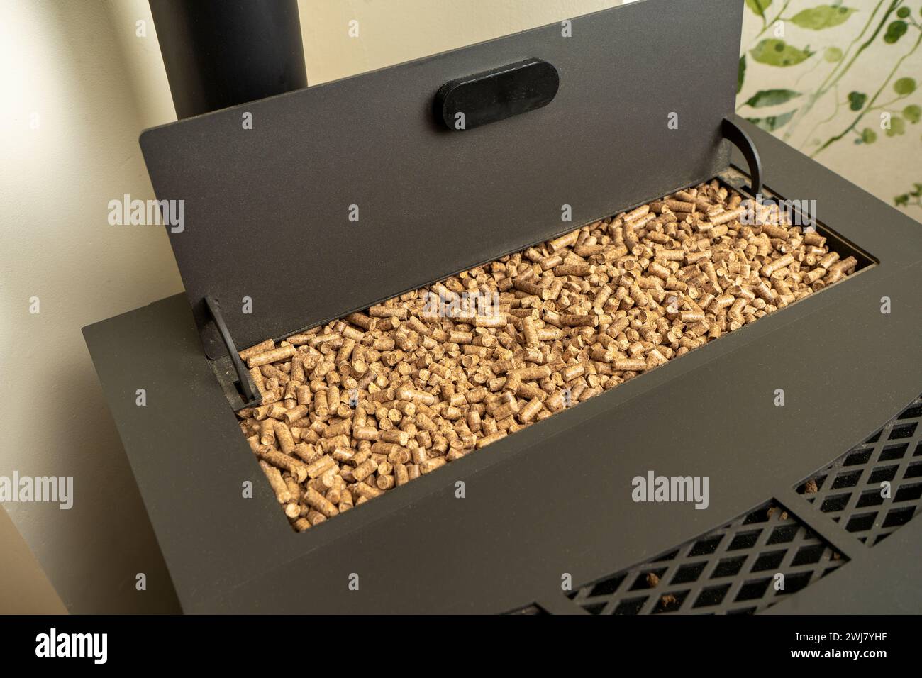 Image of a pellet stove with the hopper filled to the brim with ...