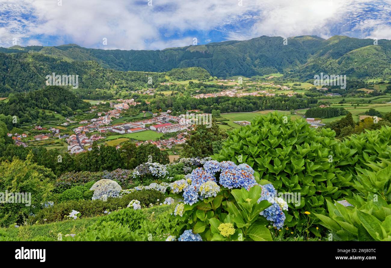 View of the Furnas valley surrounded by lush vegetation and colourful ...