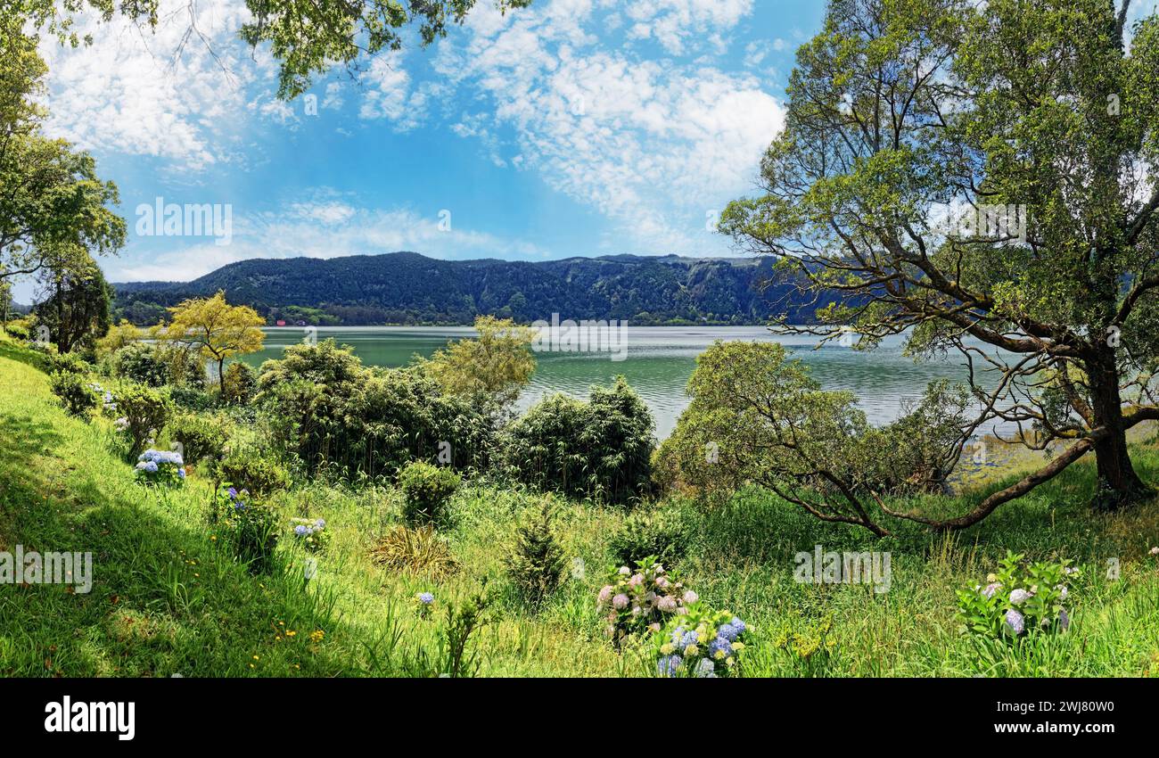 Panoramic view of Furnas Lake surrounded by grass and trees under a ...