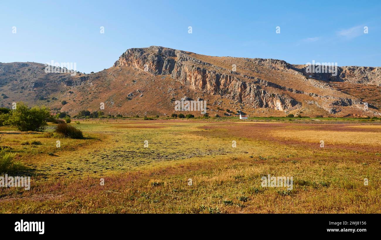 Wide meadow landscape with mountain scenery in the background under a ...
