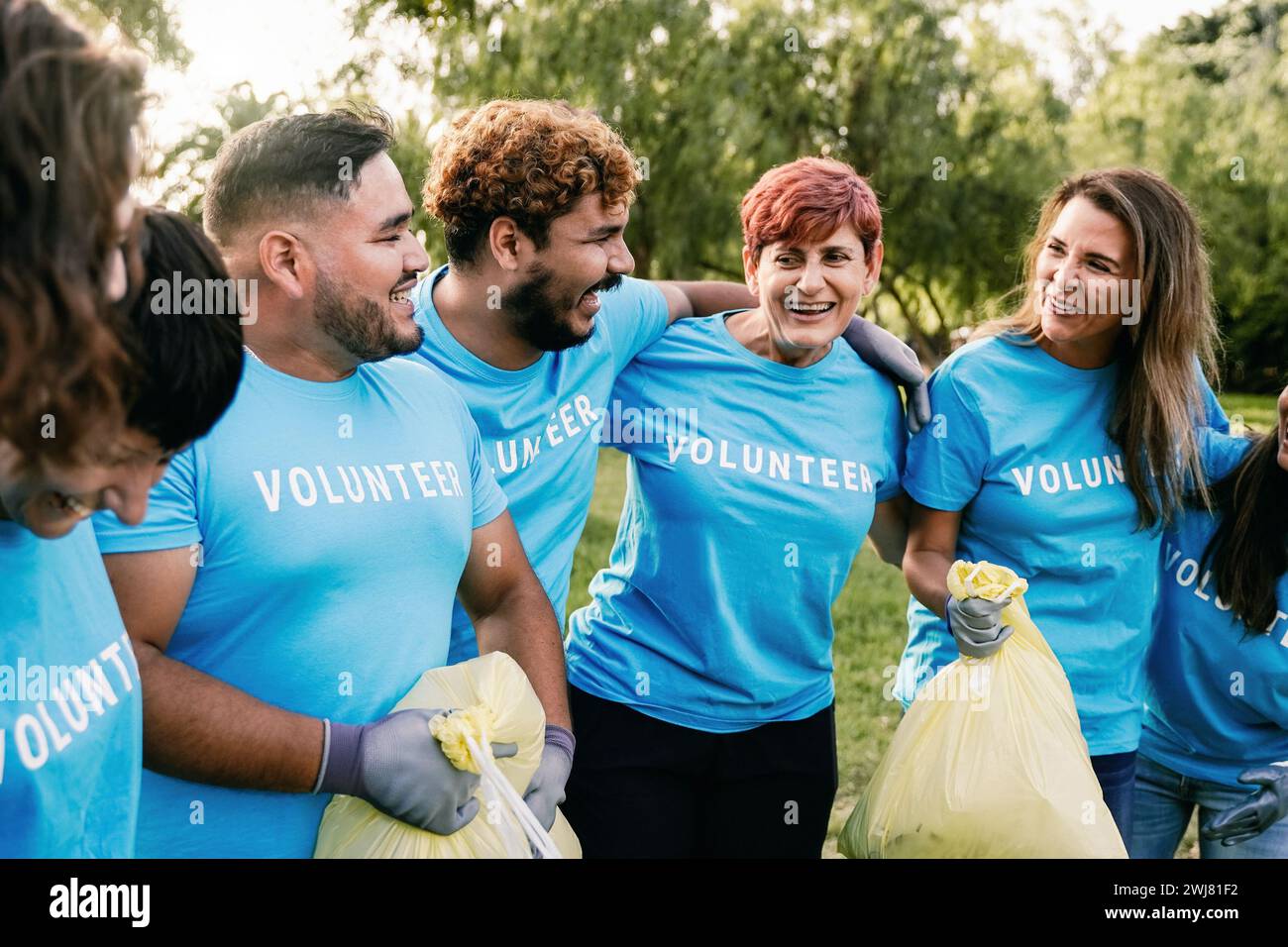 Environmental activists picking up garbage trash at park city. Group of ...