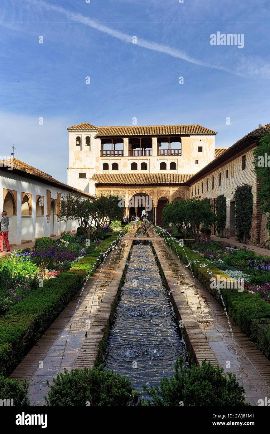 Tourists in the Patio de la Acequia, gardens with water basin, water ...