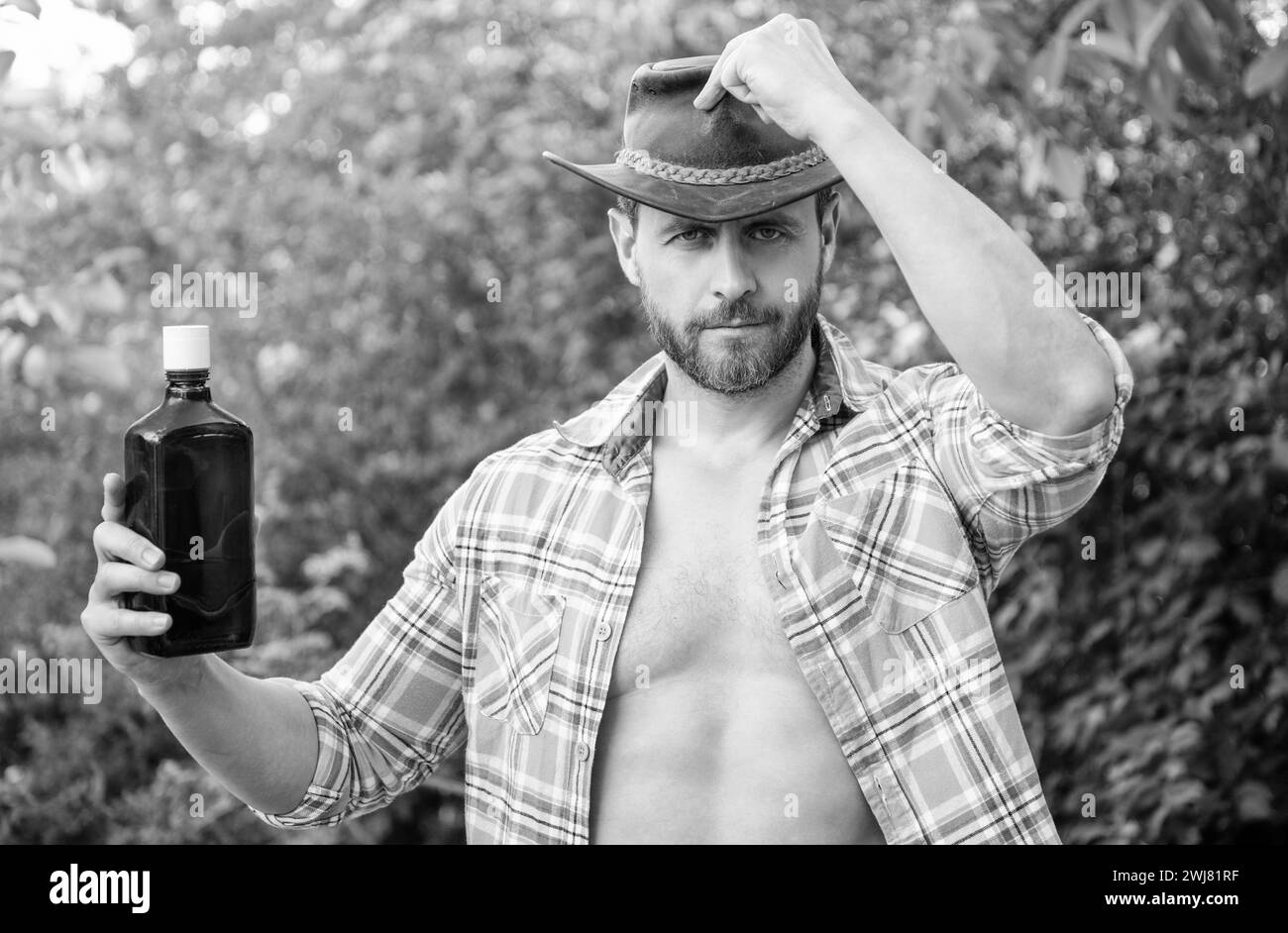 photo of cowboy man offering whiskey. cowboy man with whiskey. cowboy ...