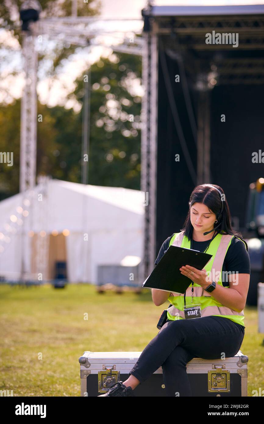 Female Production Worker Setting Up Outdoor Stage For Music Festival Or ...