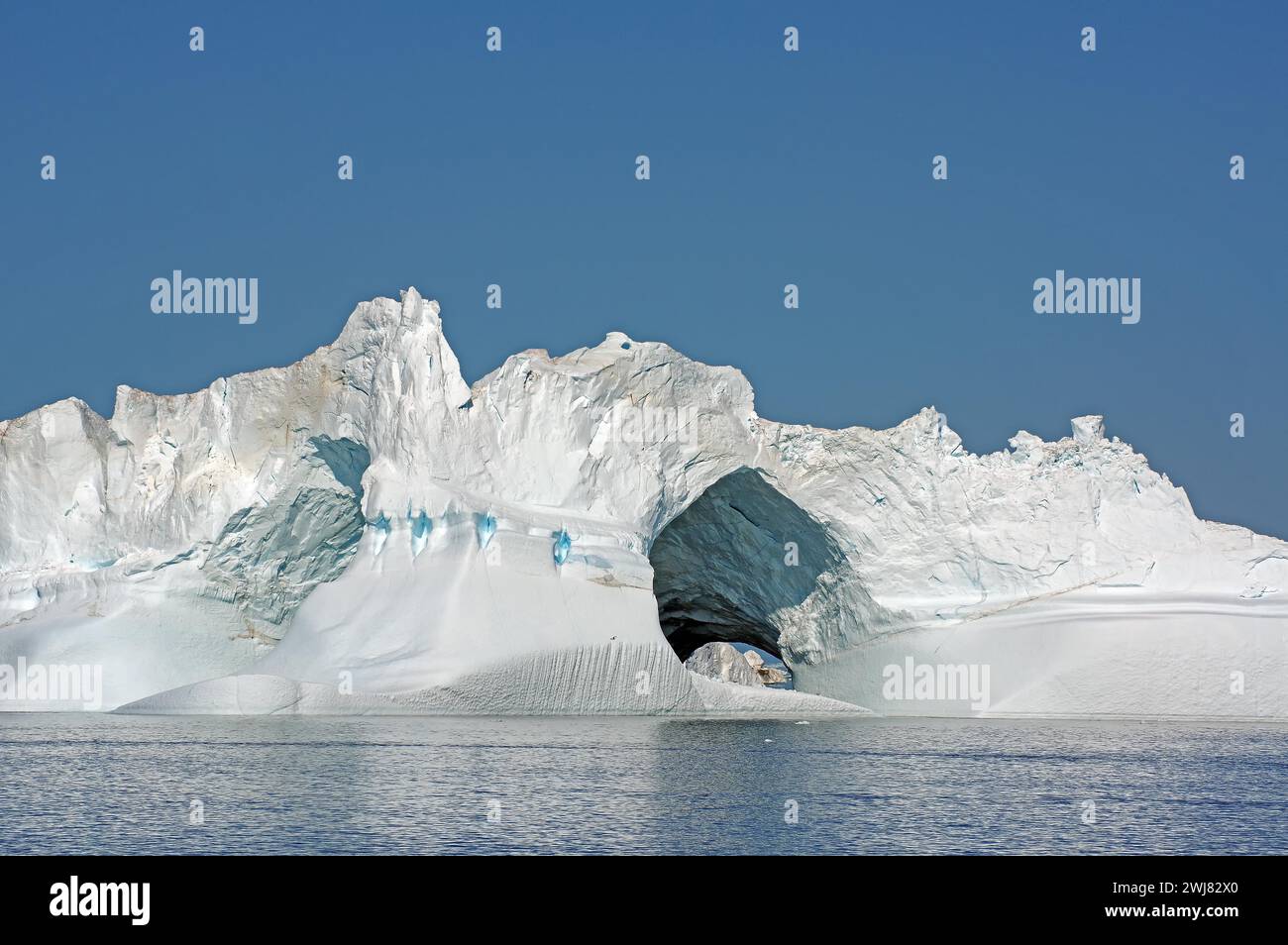 Iceberg with large ice cave, Ilulissat, Disko Bay, Denmark, Greenland ...