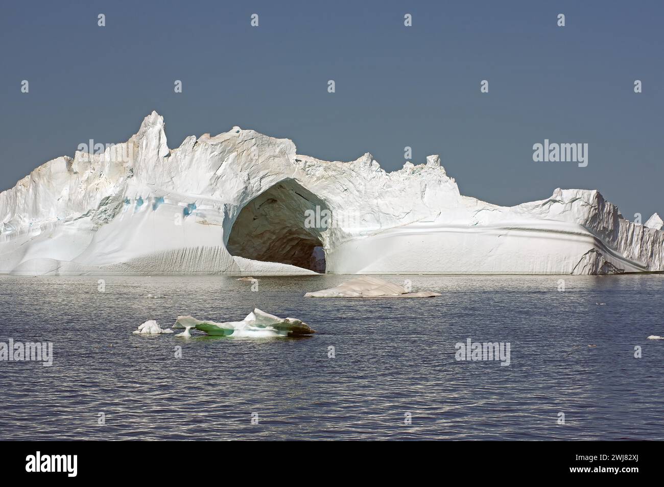 Iceberg with large ice cave, Ilulissat, Disko Bay, Denmark, Greenland ...