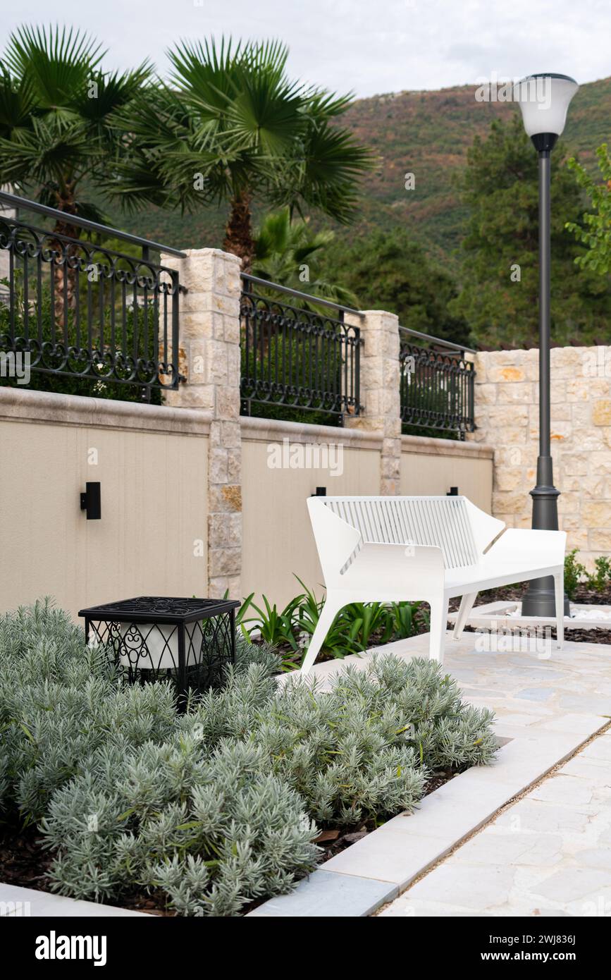 White bench in a summer resort Stock Photo - Alamy