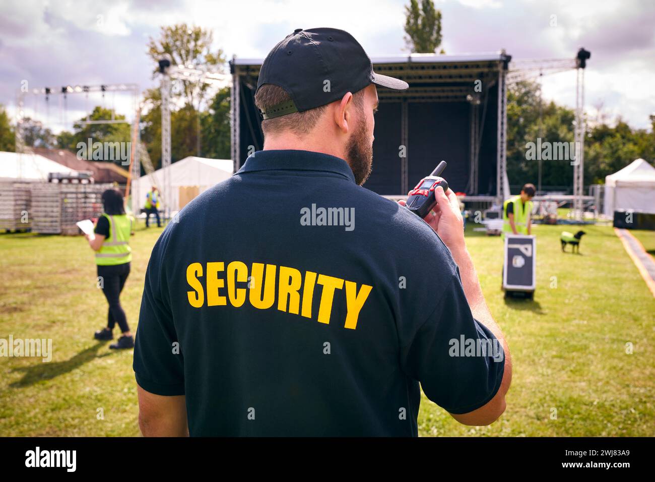 Rear View Of Security Team At Outdoor Stage For Music Festival Or ...