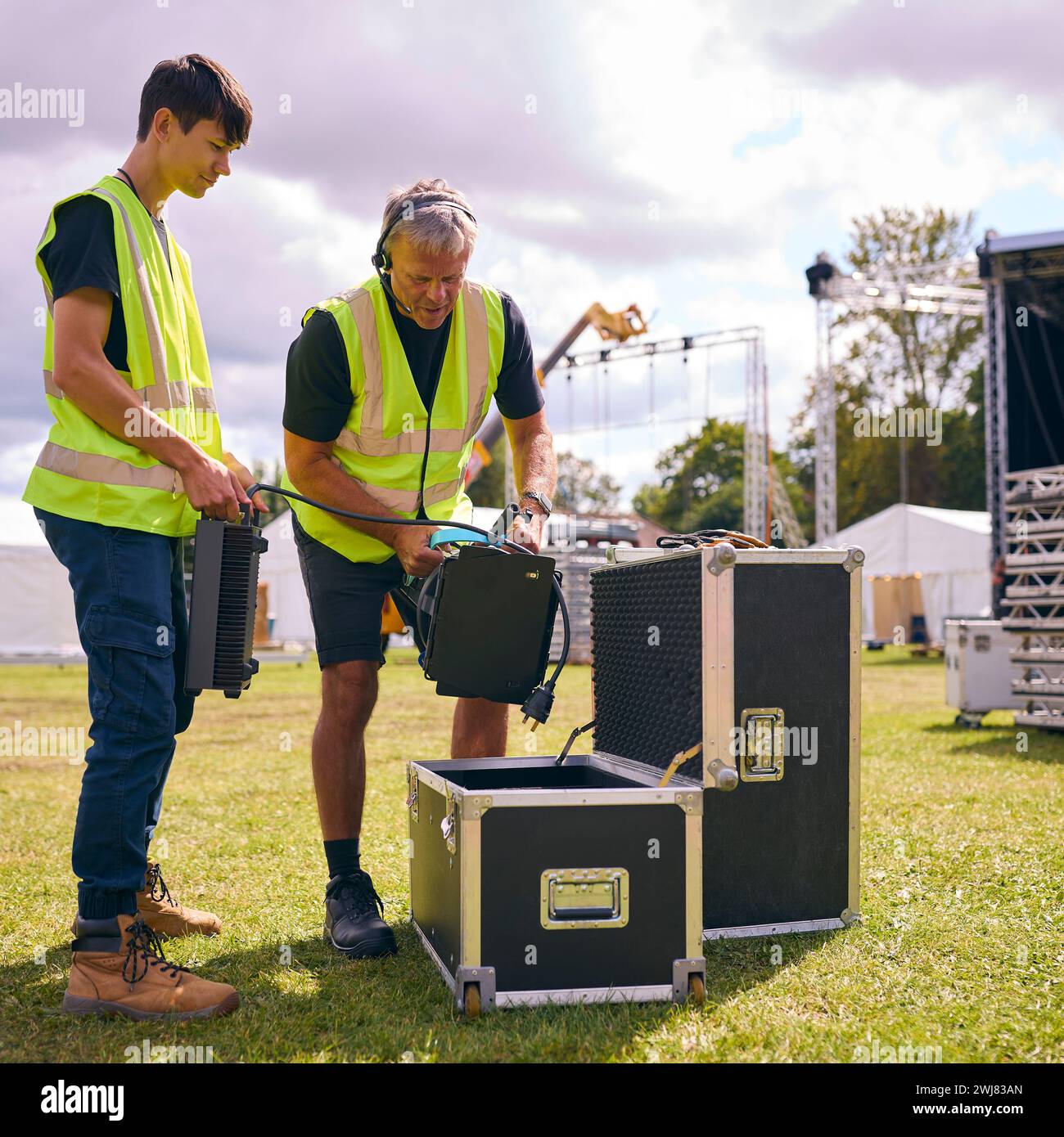 Production Team Unpacking Lights From Flight Case And Setting Up ...