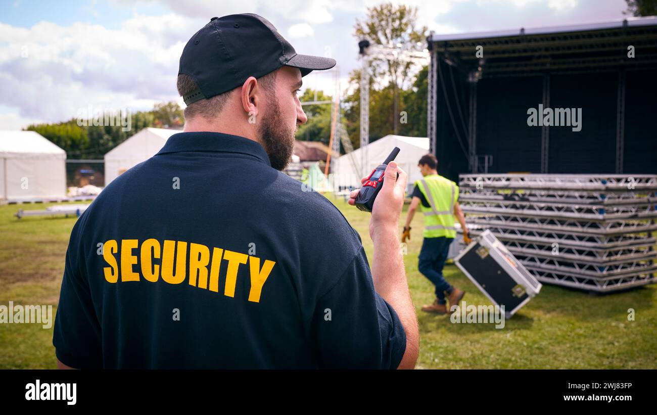 Rear View Of Security Team At Outdoor Stage For Music Festival Or ...