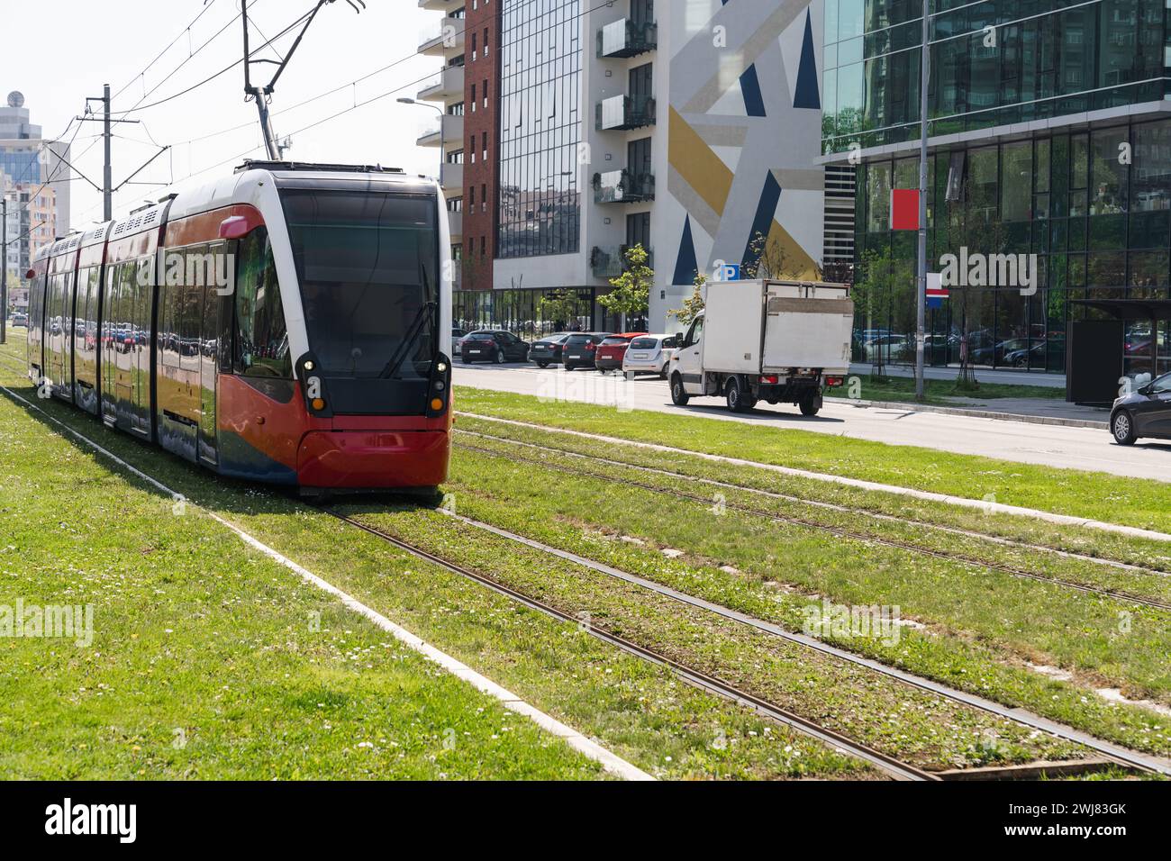 Modern tram on the city street Stock Photo - Alamy