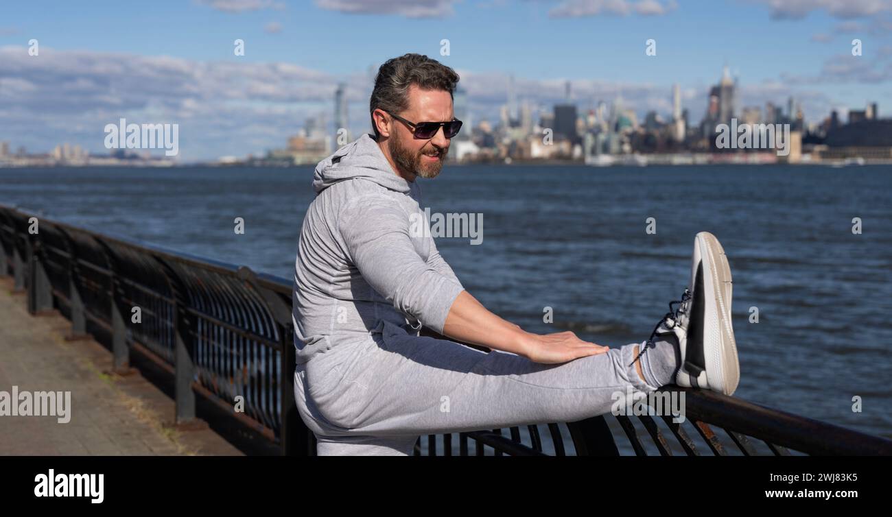 Stretching routine of athlete outdoor. Athlete stretching his muscles ...