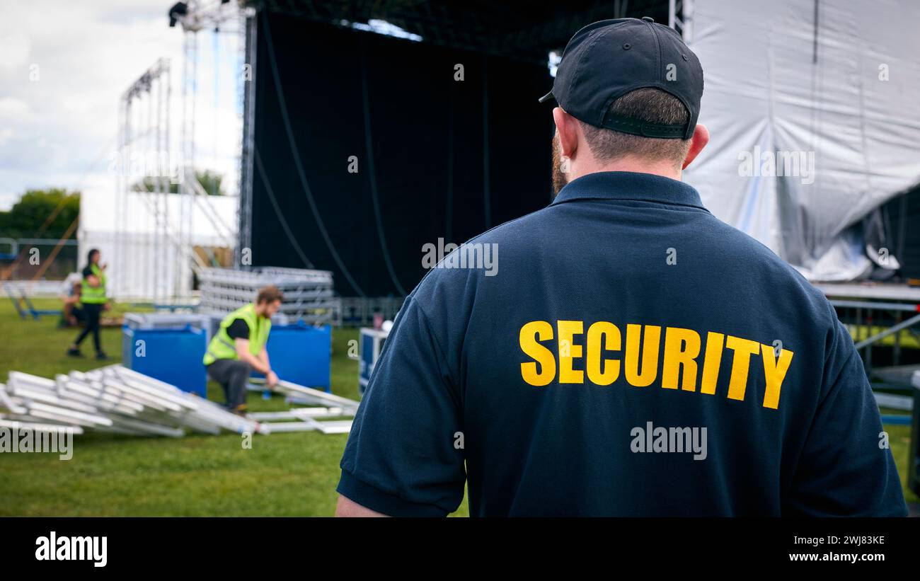 Rear View Of Security Team At Outdoor Stage For Music Festival Or ...