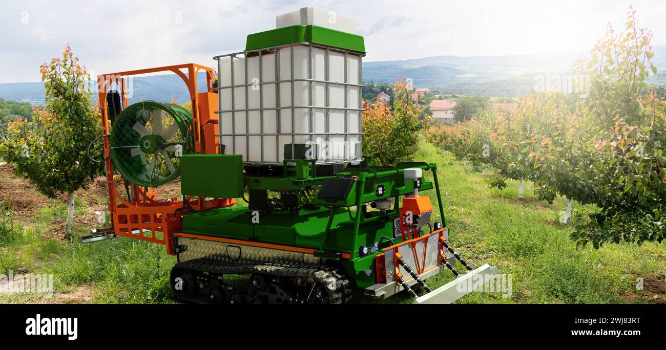 Autonomous robot sprayer works in a fruit garden. Smart farming concept ...