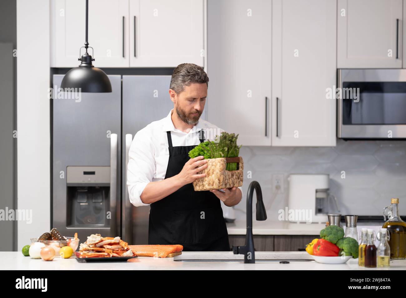 Man cooking home food. Healthy food, cooking concept. Mature man in ...