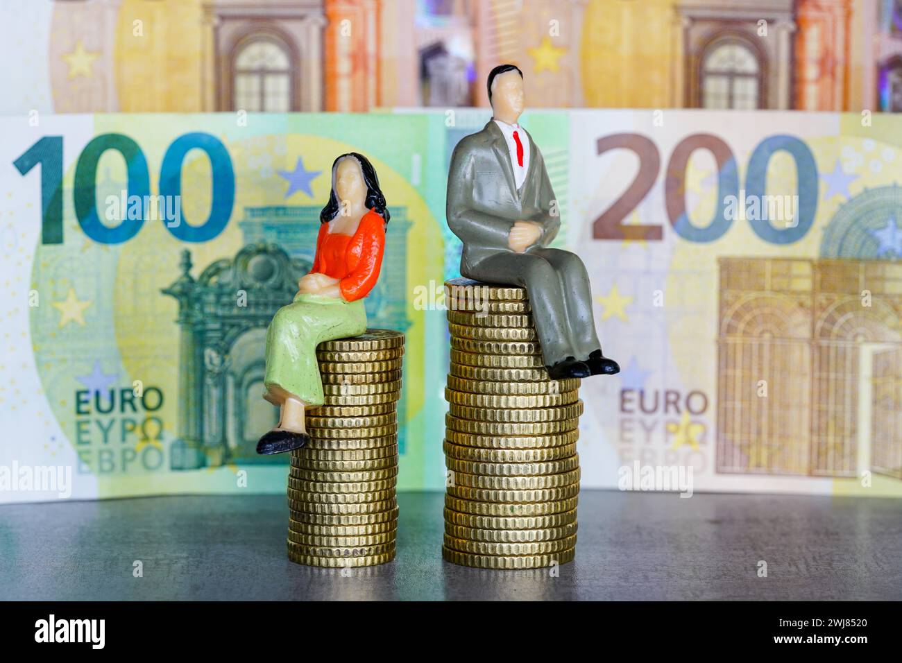 Figures of male and female people on different piles of money coins ...