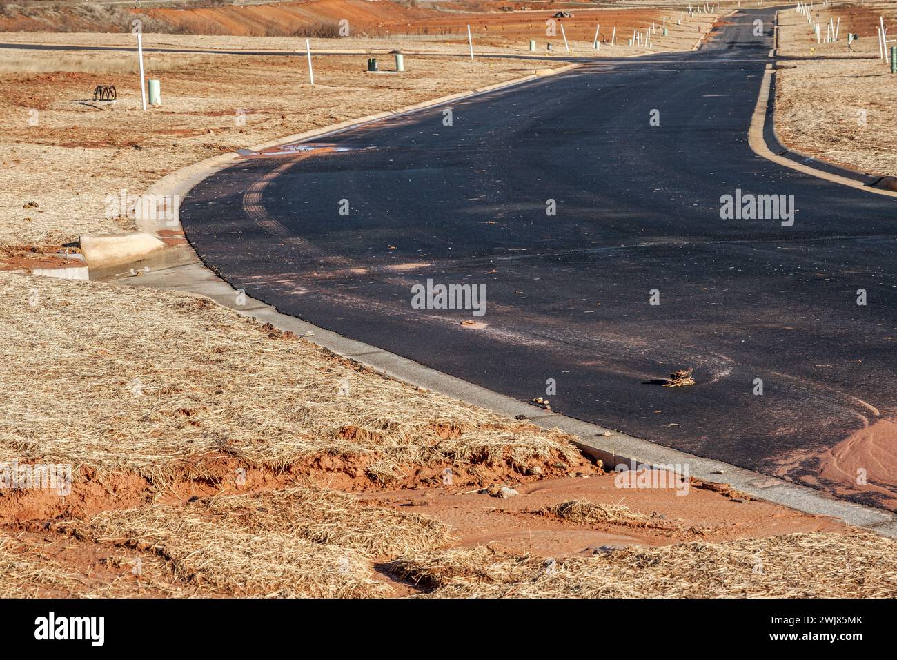 Blacktop road and curb system installed in a new residential ...
