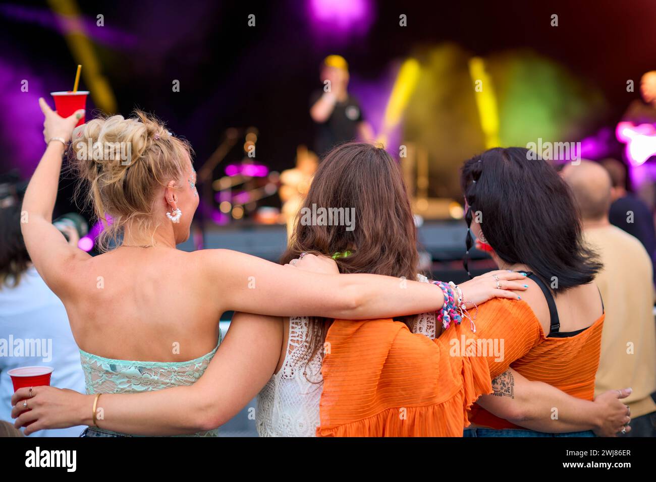 Rear View Of Three Female Friends Dancing At Summer Music Festival ...