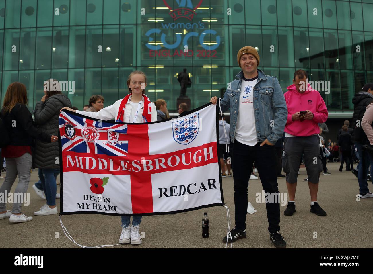 Girl and man hold Middlesbrough Redcar England flag before England v ...