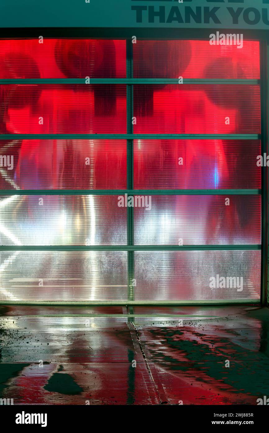 Automatic car wash exit overhead door at night Stock Photo - Alamy