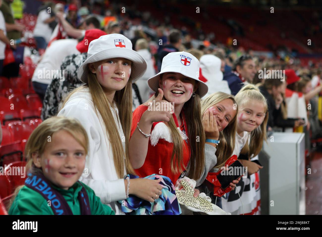 Young female fans in England hats and facepaint smile give thumbs up ...