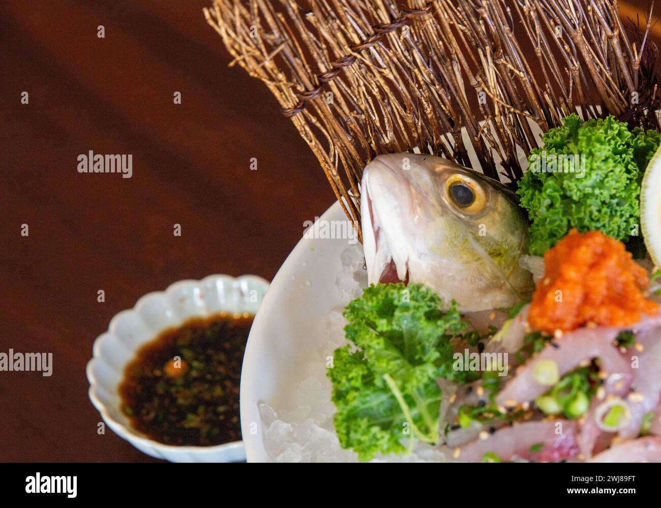 Sashimi presentation with fish head served Stock Photo - Alamy