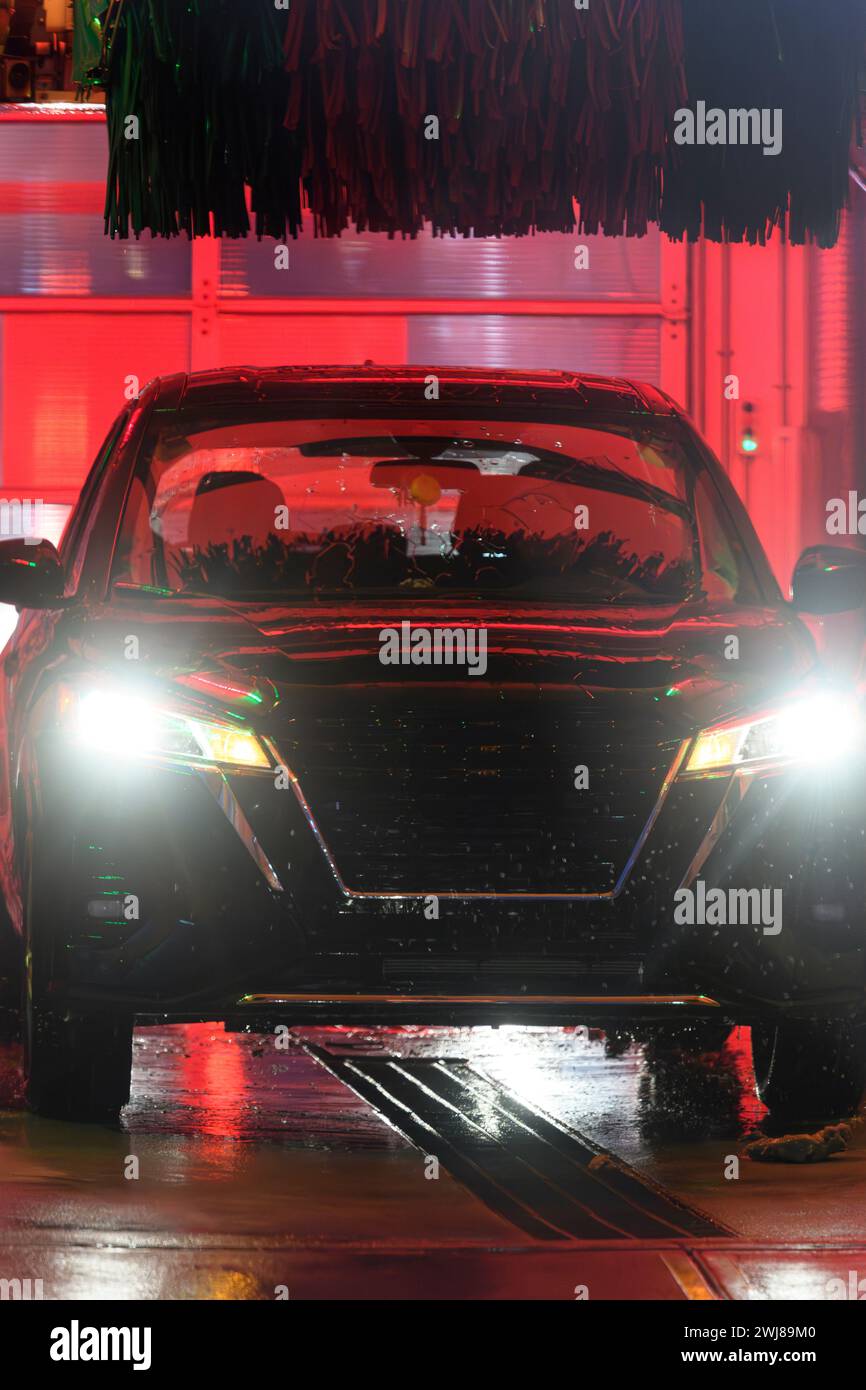 Automatic car wash exit overhead door at night Stock Photo - Alamy