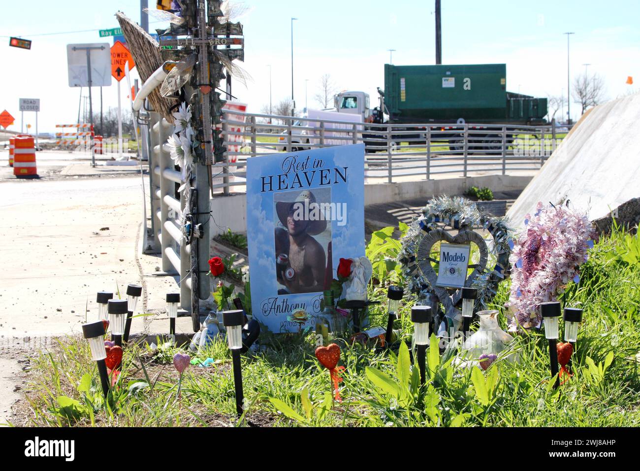 Flowers, crosses and a photo are part of a roadside memorial along the ...