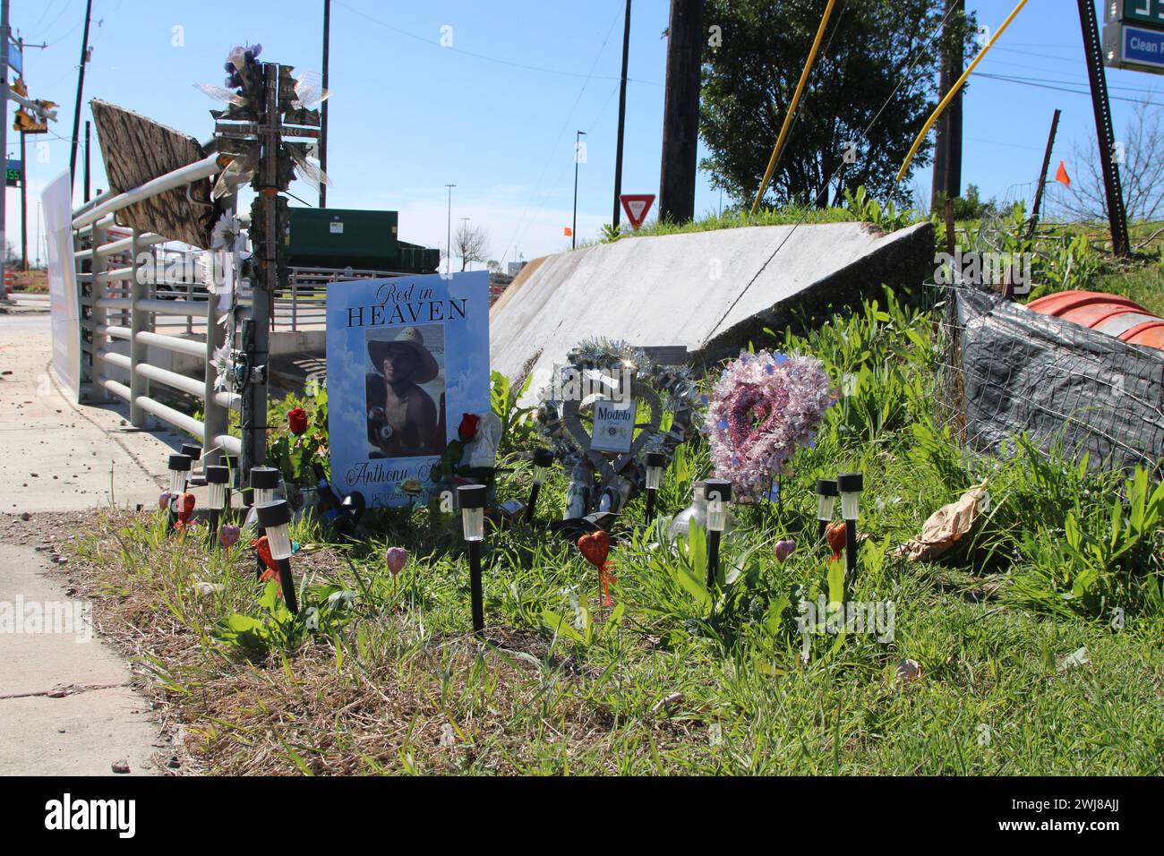 Flowers, crosses and a photo are part of a roadside memorial along the ...