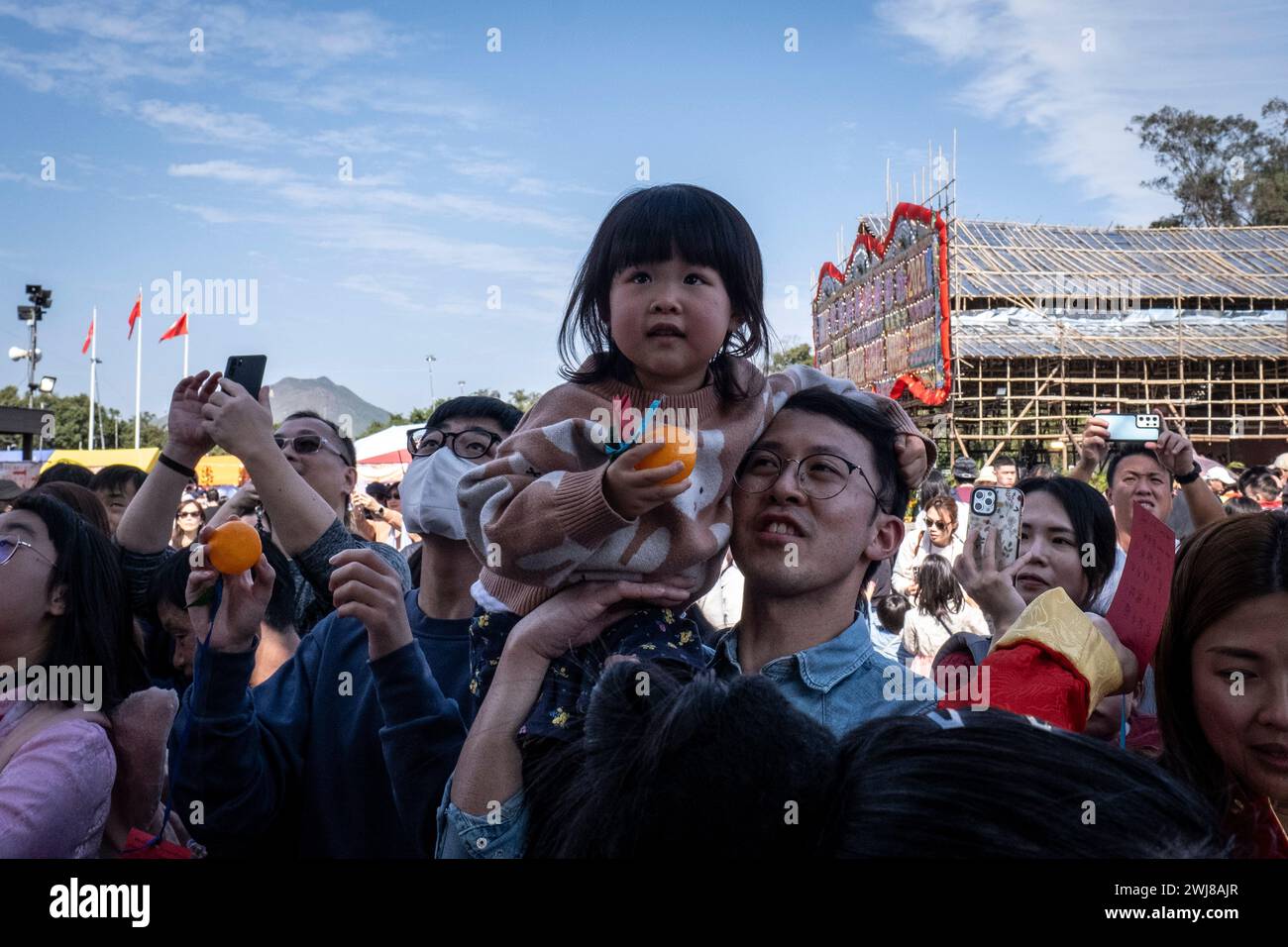 A father and his child participate in the throwing of the wish placard ...