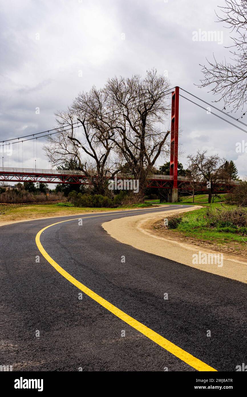 Curving road alongside picturesque bridge and river Stock Photo - Alamy