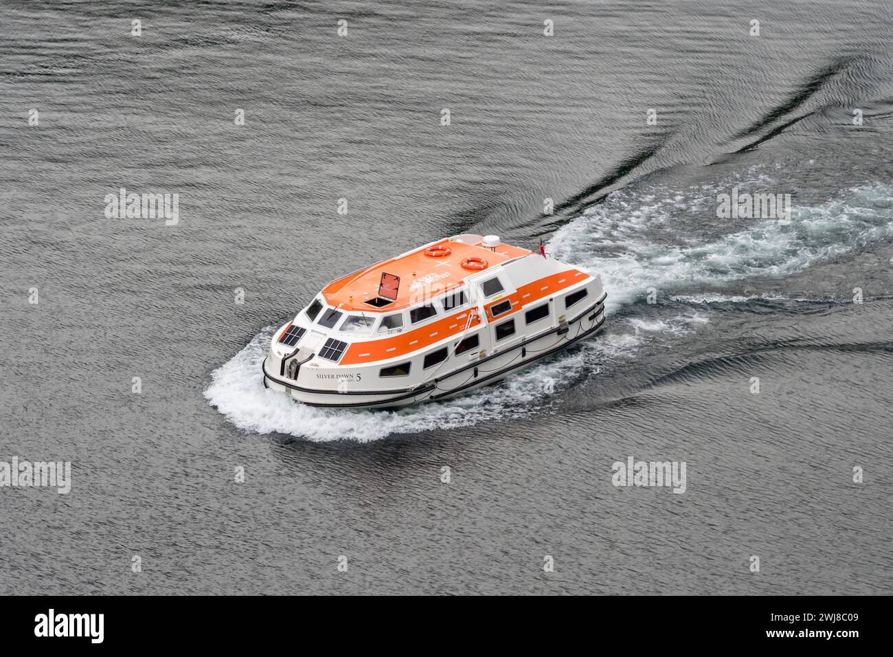 A Silversea 'Silver Dawn' cruise ship tender taking passengers back to ...