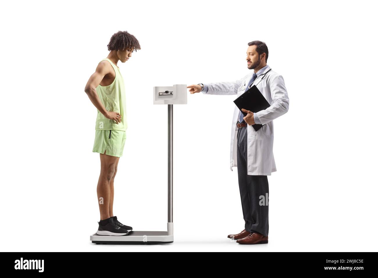 Doctor measuring a african american athlete on a medical weight scale ...