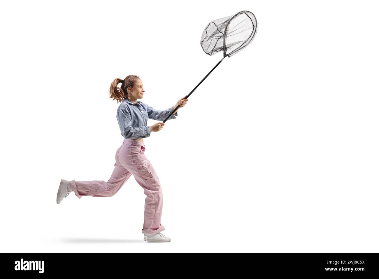 Teenage girl running and holding a catching net isolated on white ...