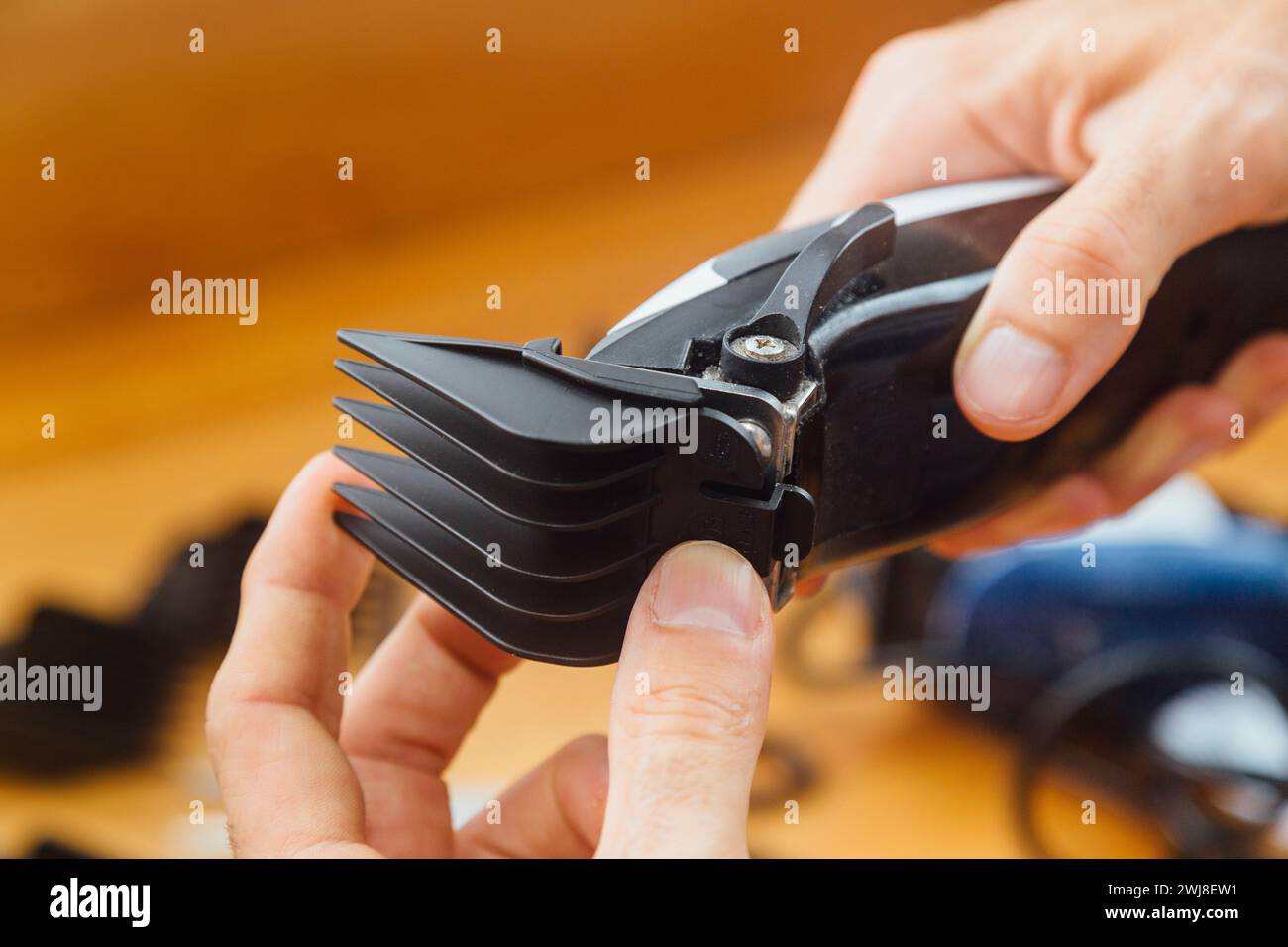 Hairdresser changing the comb of his hair clipper machine Stock Photo ...