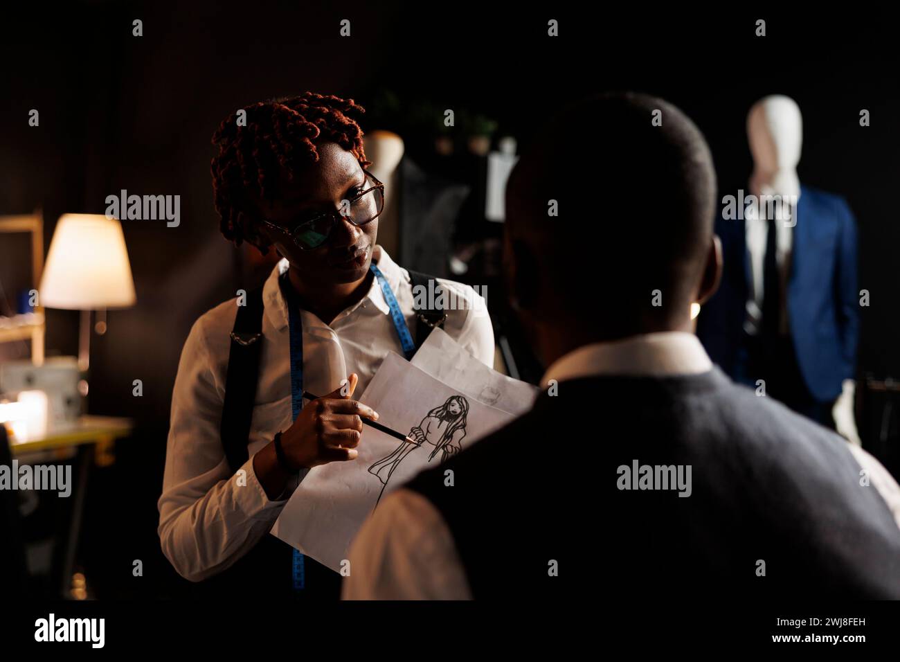 African american dressmaker showing tailoring studio coworker sketch ...