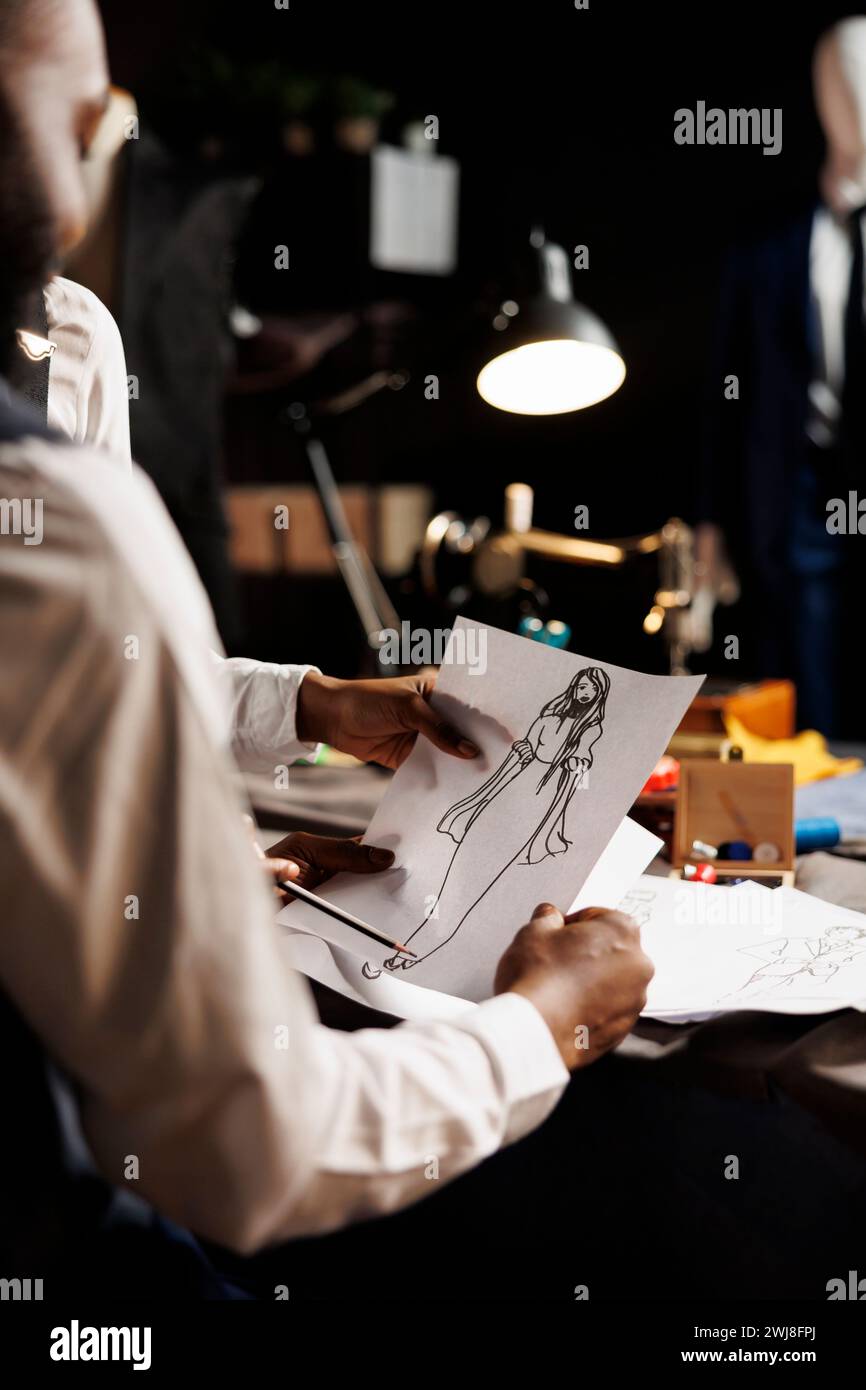 Tailoring studio workspace collegues brainstorming best adjustments to ...