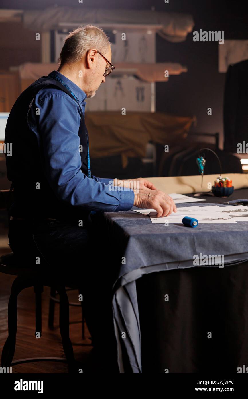 Couturer designing for upcoming fashion runway show project ...