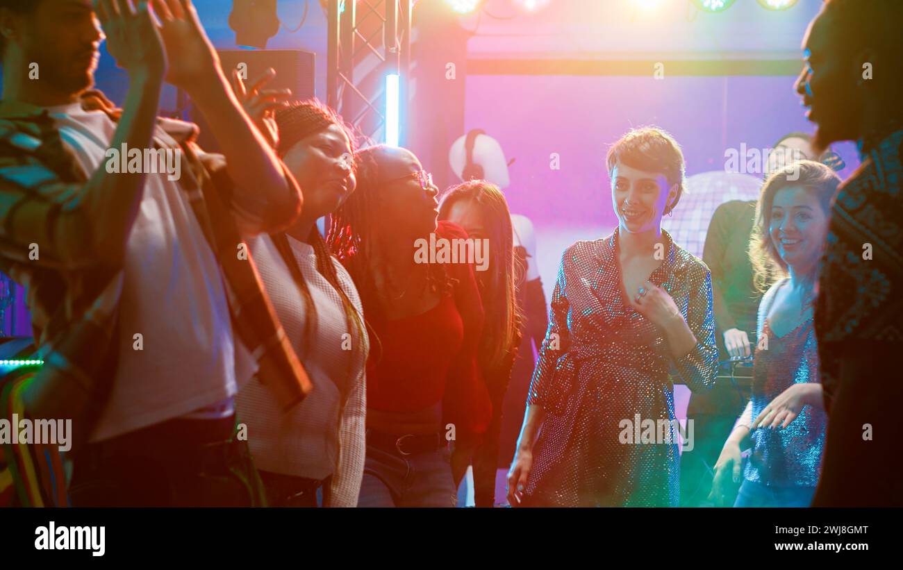 Young adults having fun dancing at party, enjoying breakdance battle ...