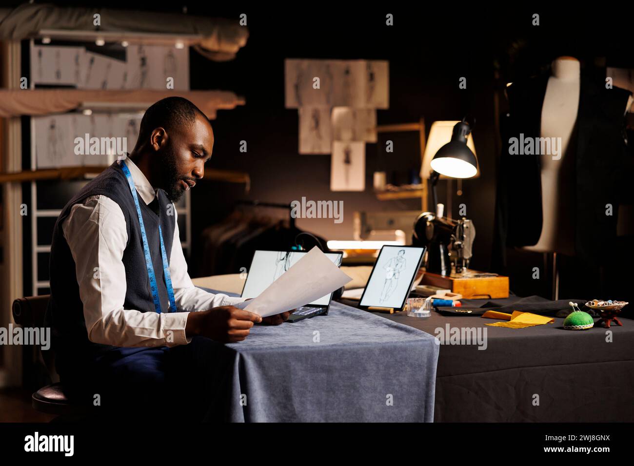 African american fashion designer conceptualizing custom made sartorial collection for upcoming ...