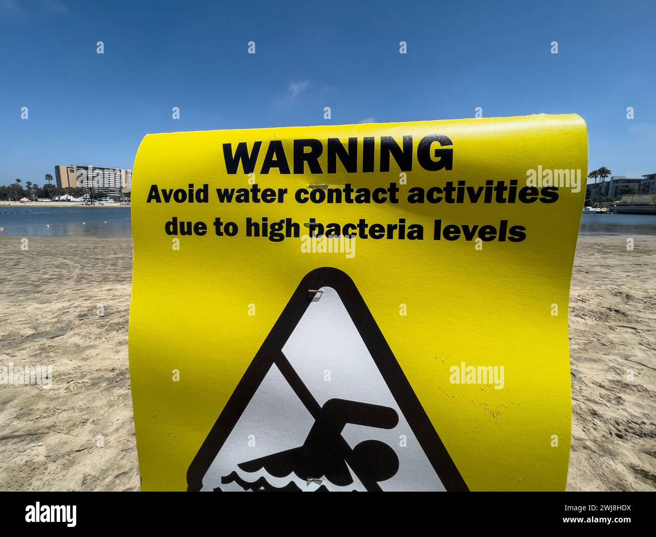 Warning avoid water contact activities due to high bacteria levels sign ...