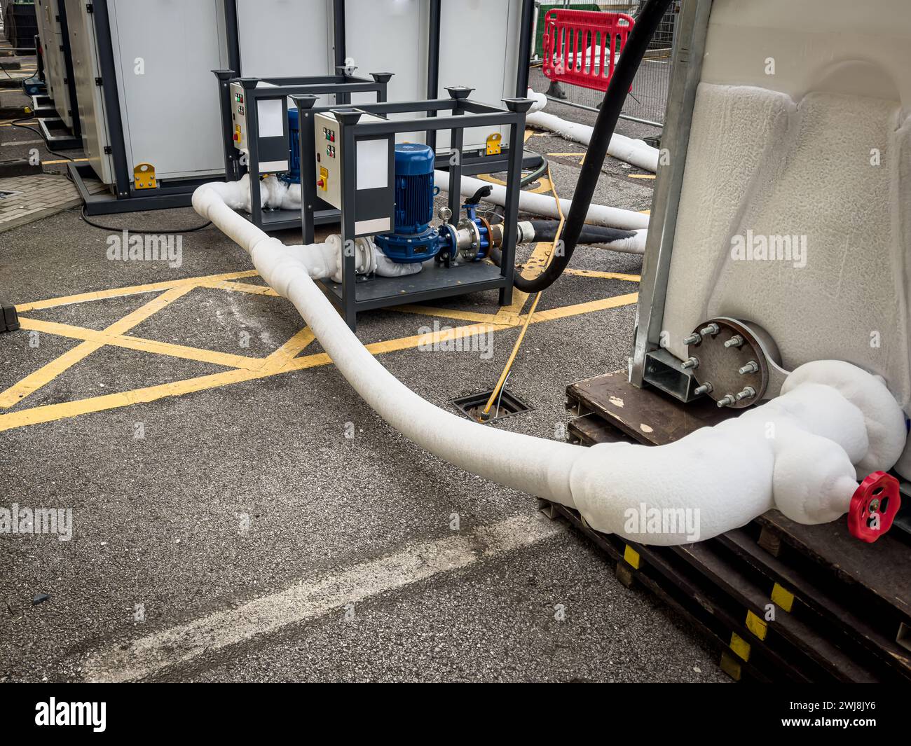 Metal pipes covered with a layer of frost. Industrial refrigerating ...