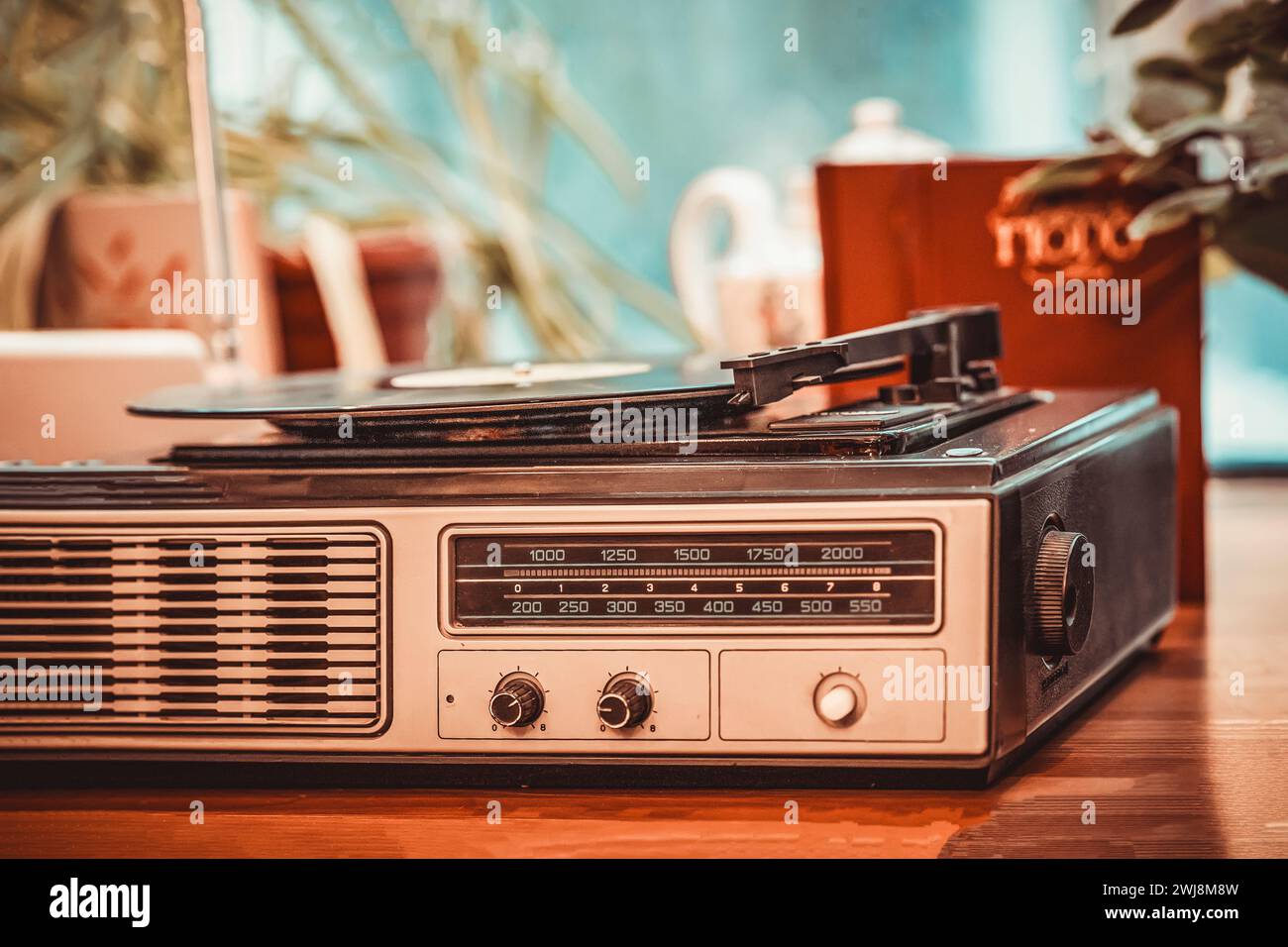Closeup of vintage record player turntable with record inside old room ...
