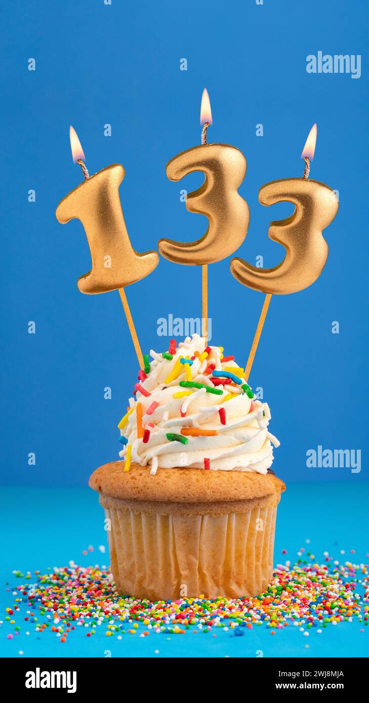 Candle number 133 - Cupcake birthday in blue background Stock Photo - Alamy