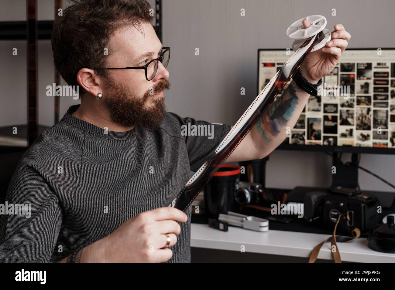 Photographer Examining Film with Precision Stock Photo - Alamy