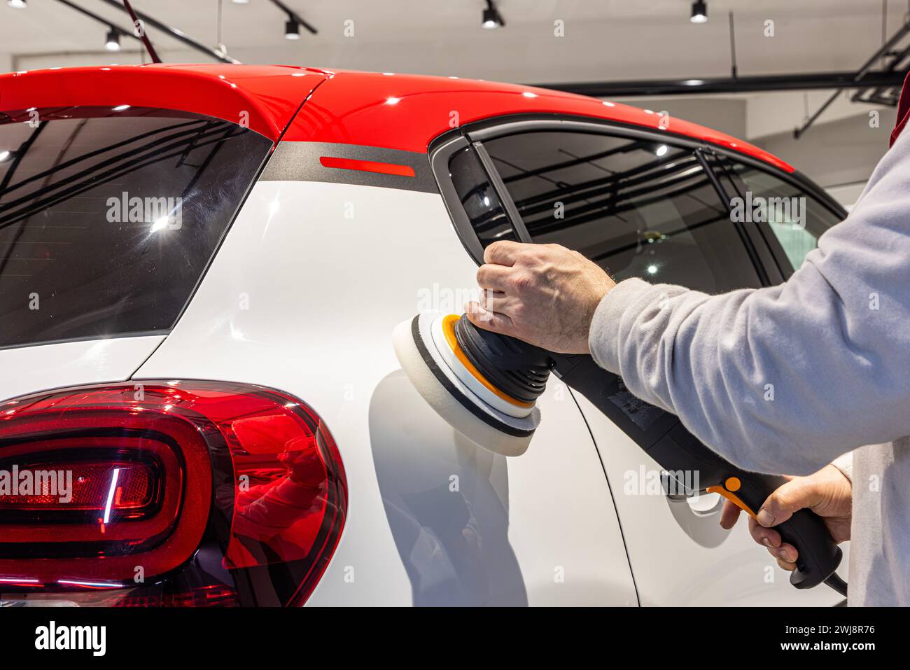 Master is polishing the car. Master mechanic removal of dents defects ...