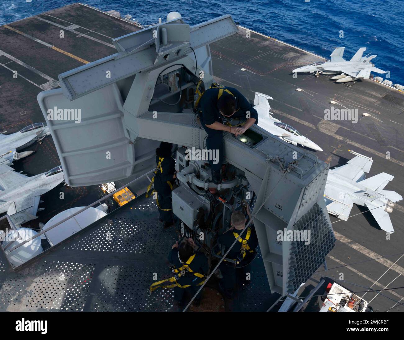 240203-N-PQ495-1035 PHILIPPINE SEA (Feb. 3, 2024) Sailors perform maintenance on anthe AN/SPN-43 ...